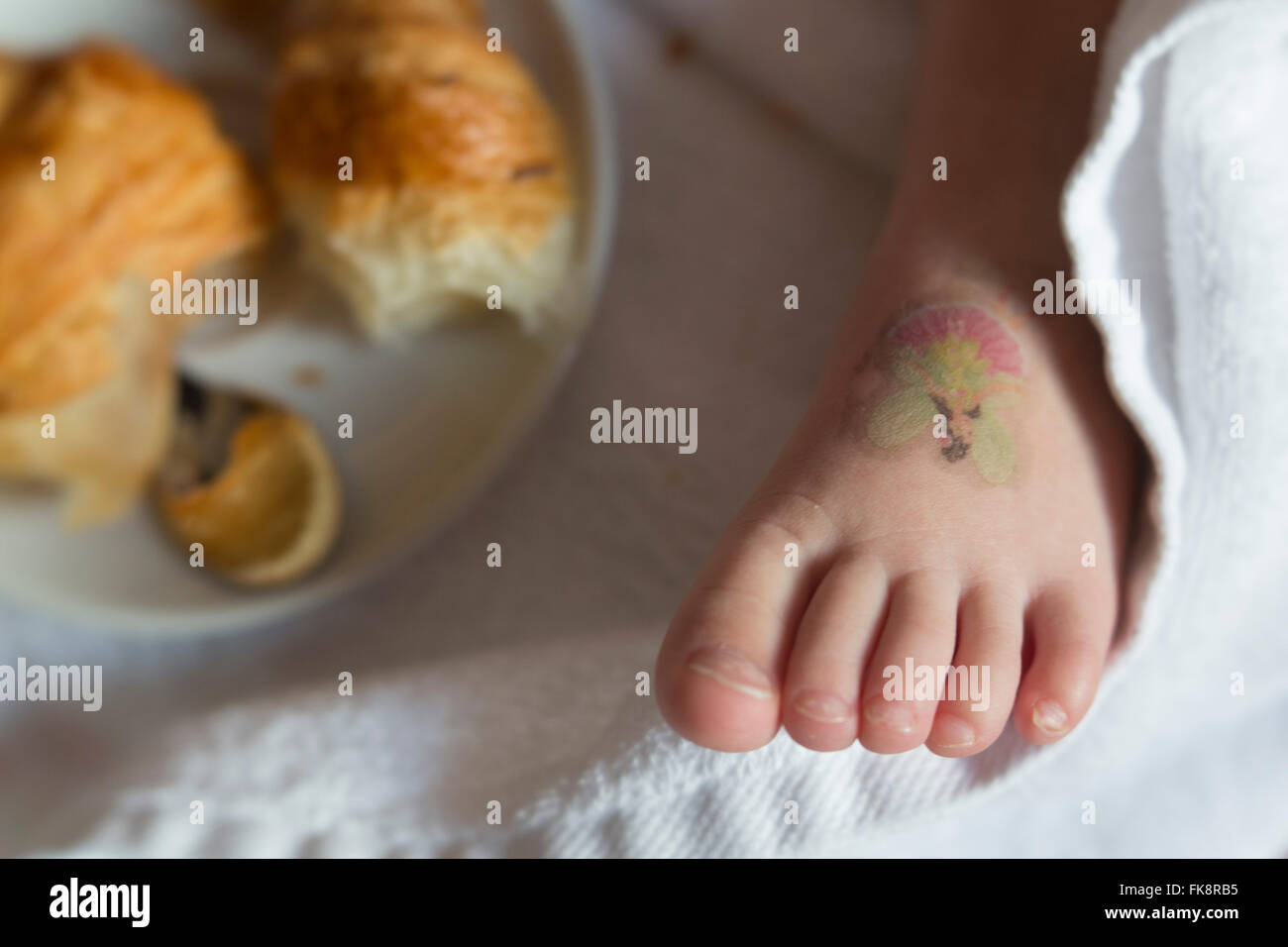 Little girl eating breakfast in pajamas on a hotel room floor Stock ...