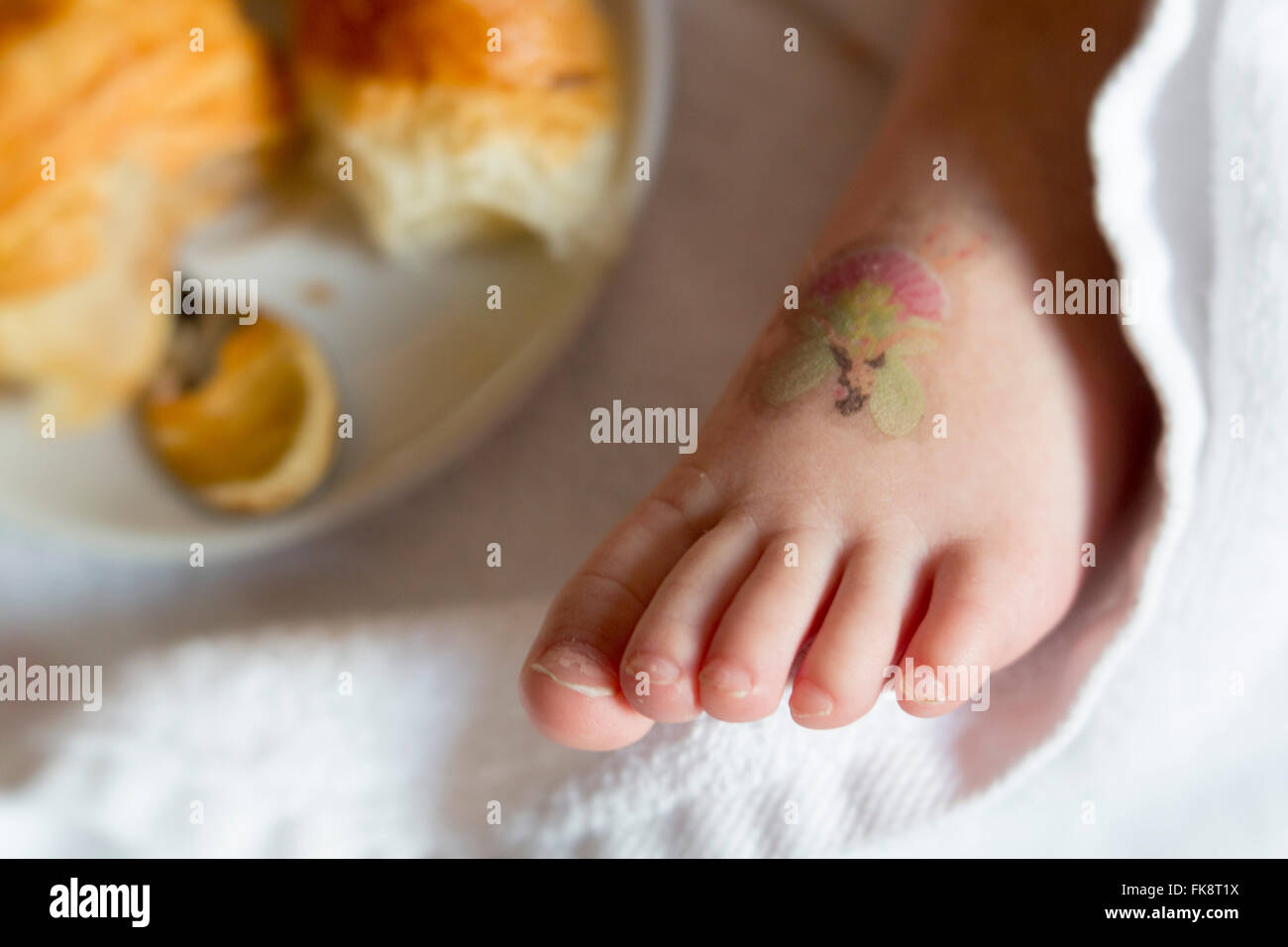 Little girl eating breakfast in pajamas on a hotel room floor Stock ...