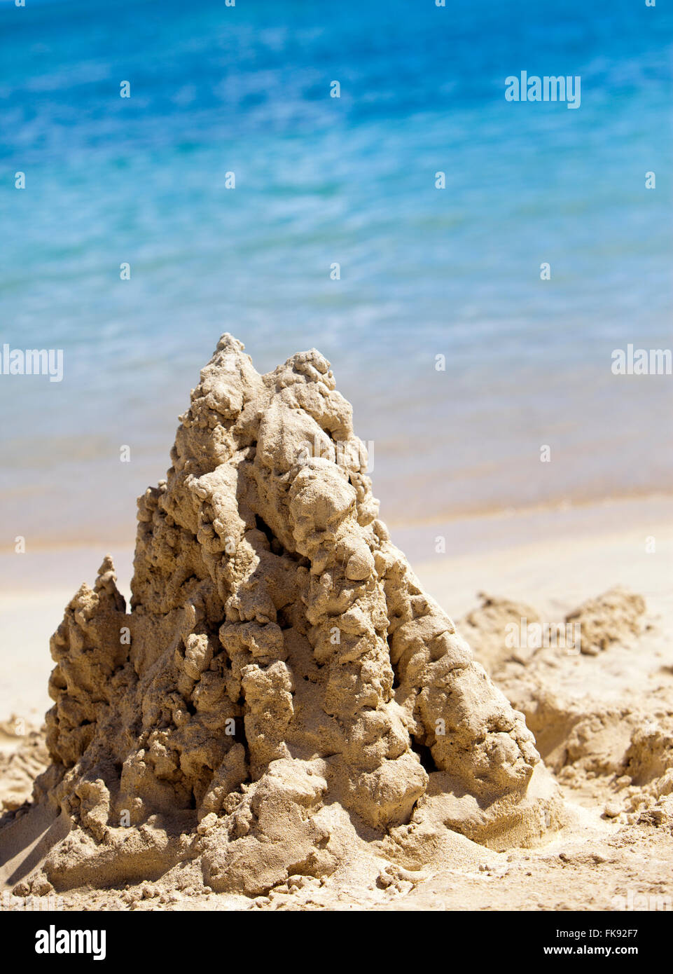 Sandy castle at the sea edge Stock Photo - Alamy