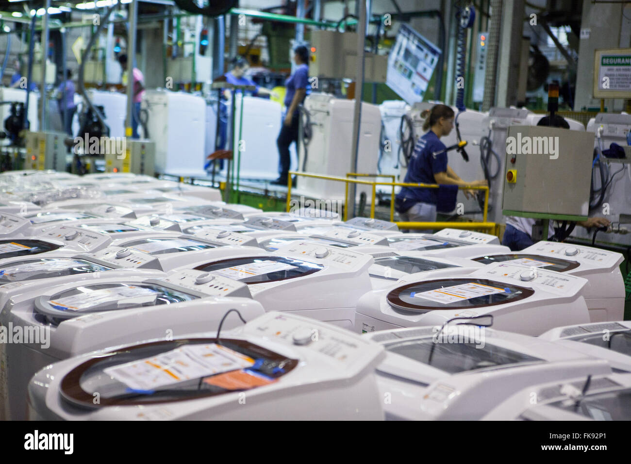 Workers` working on the assembly line manufactures washing machines and ...