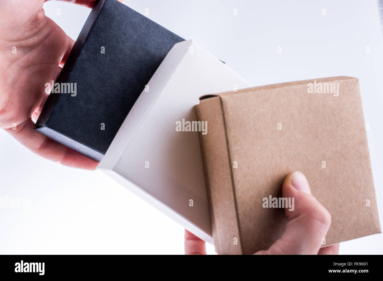 Hand holding cardboard Boxes on a white background Stock Photo - Alamy