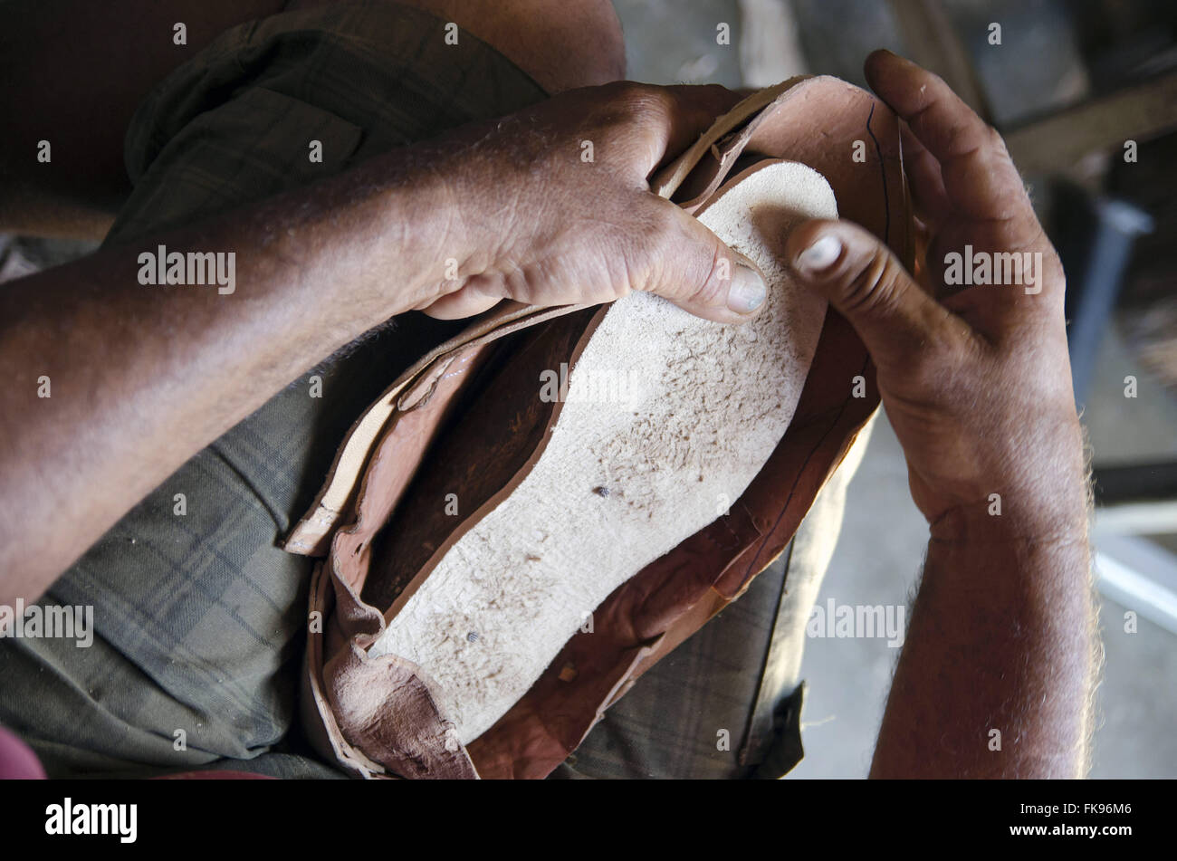 Leather craftsman producing shoes manually workshop in Pernambuco ...
