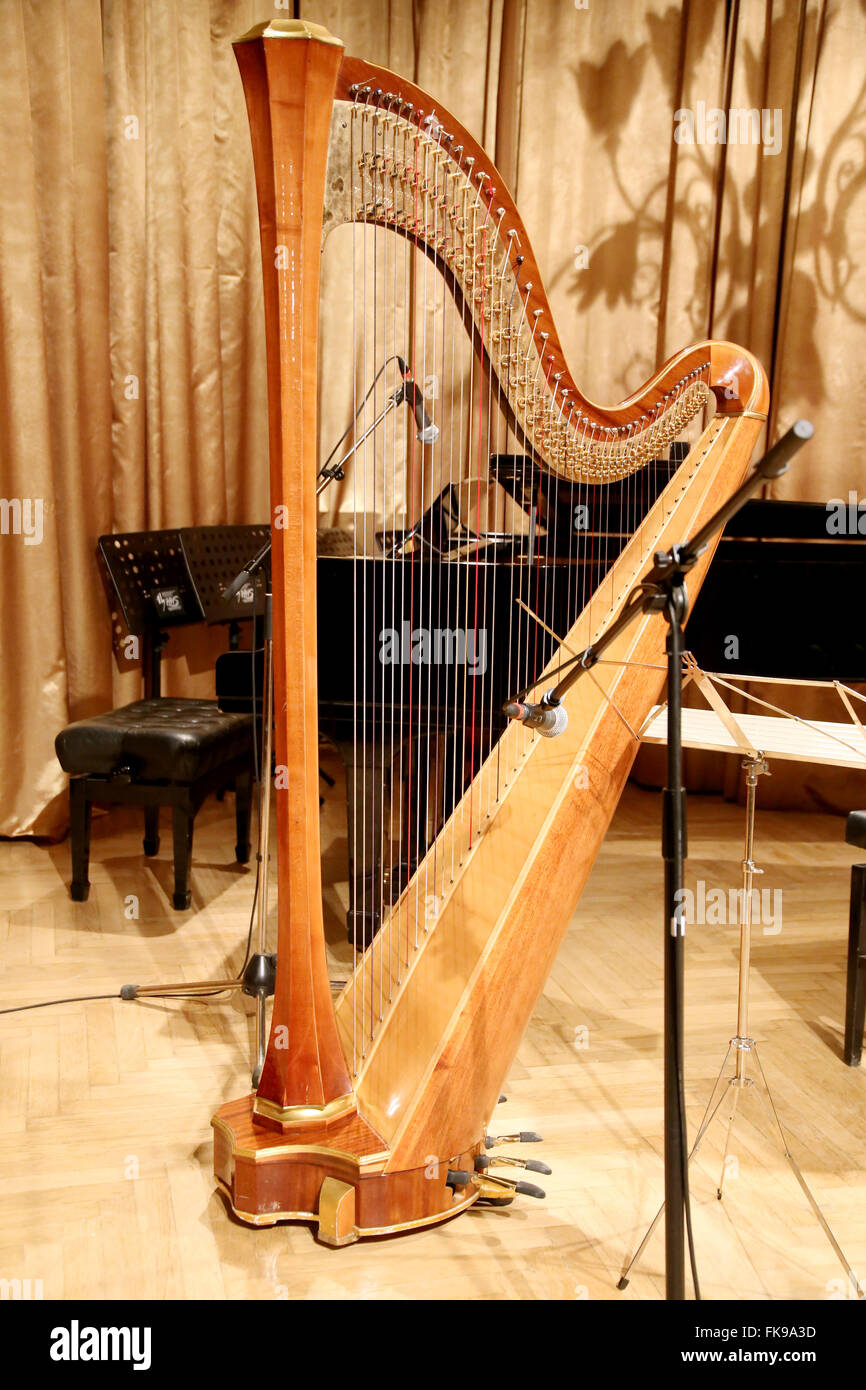 Beautiful golden harp in the auditorium before concert Stock Photo - Alamy