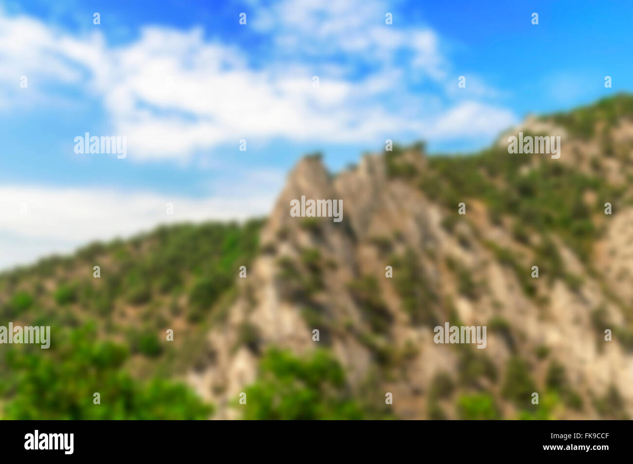Blurred mountain landscape under blue sky Stock Photo - Alamy