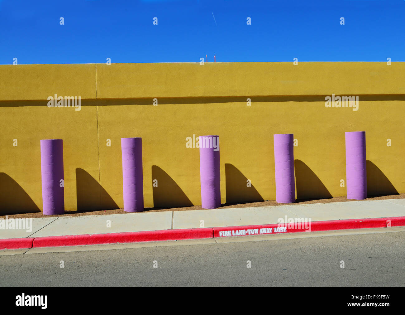 Colored concrete poles and contrasting colored walls Stock Photo - Alamy
