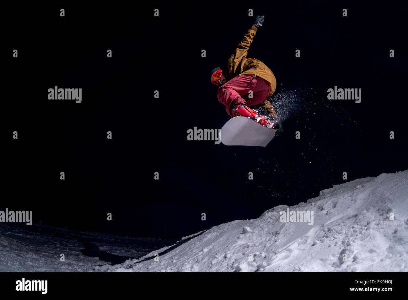 Snowboarder jumping at night Stock Photo - Alamy