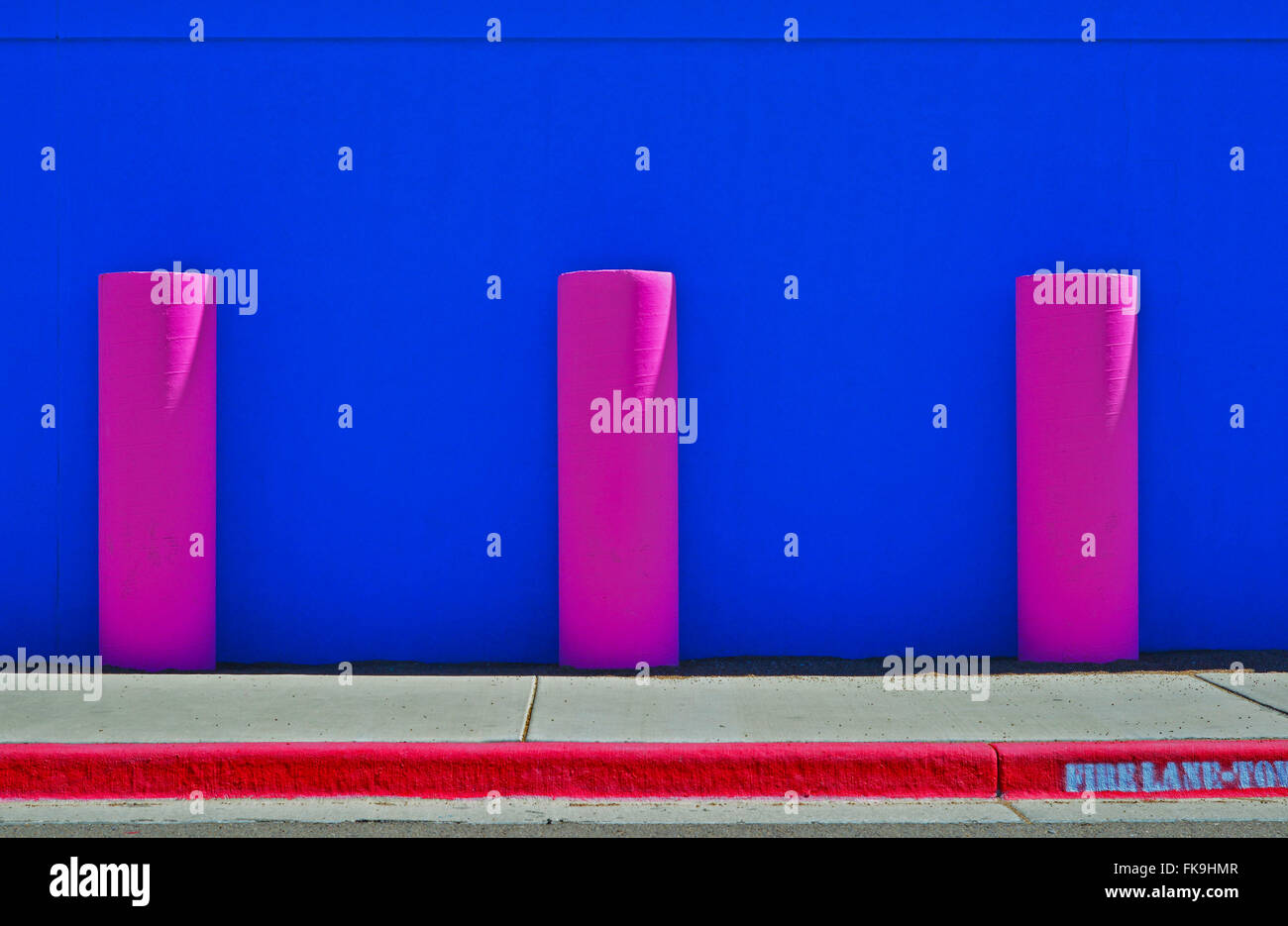 Colored concrete poles and contrasting colored walls Stock Photo - Alamy