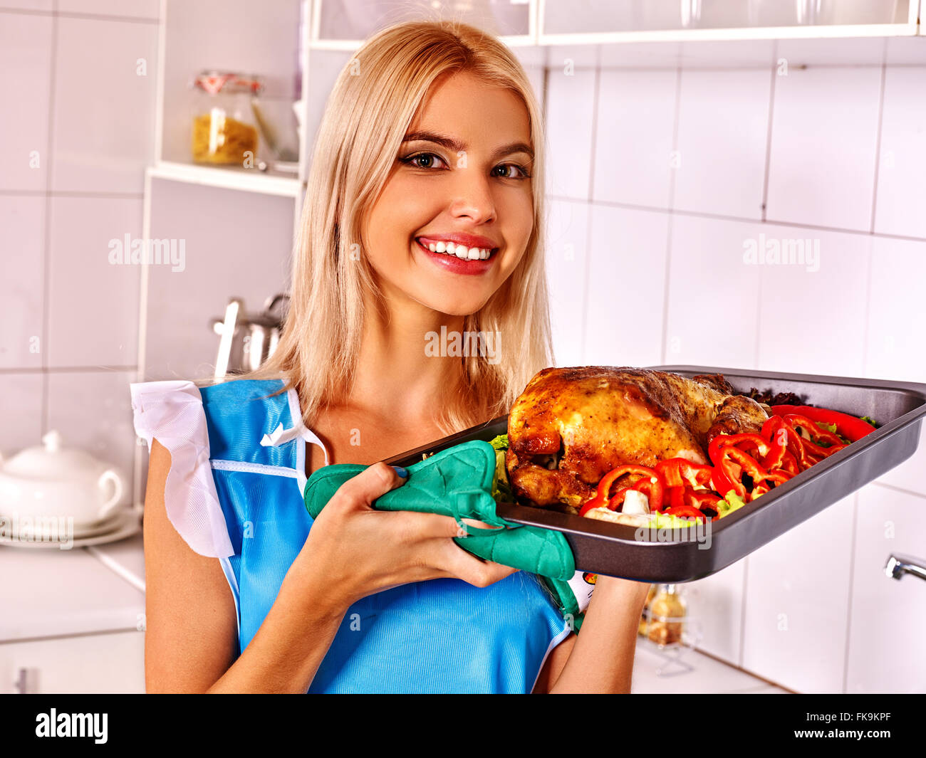 Woman cooking chicken at kitchen Stock Photo - Alamy