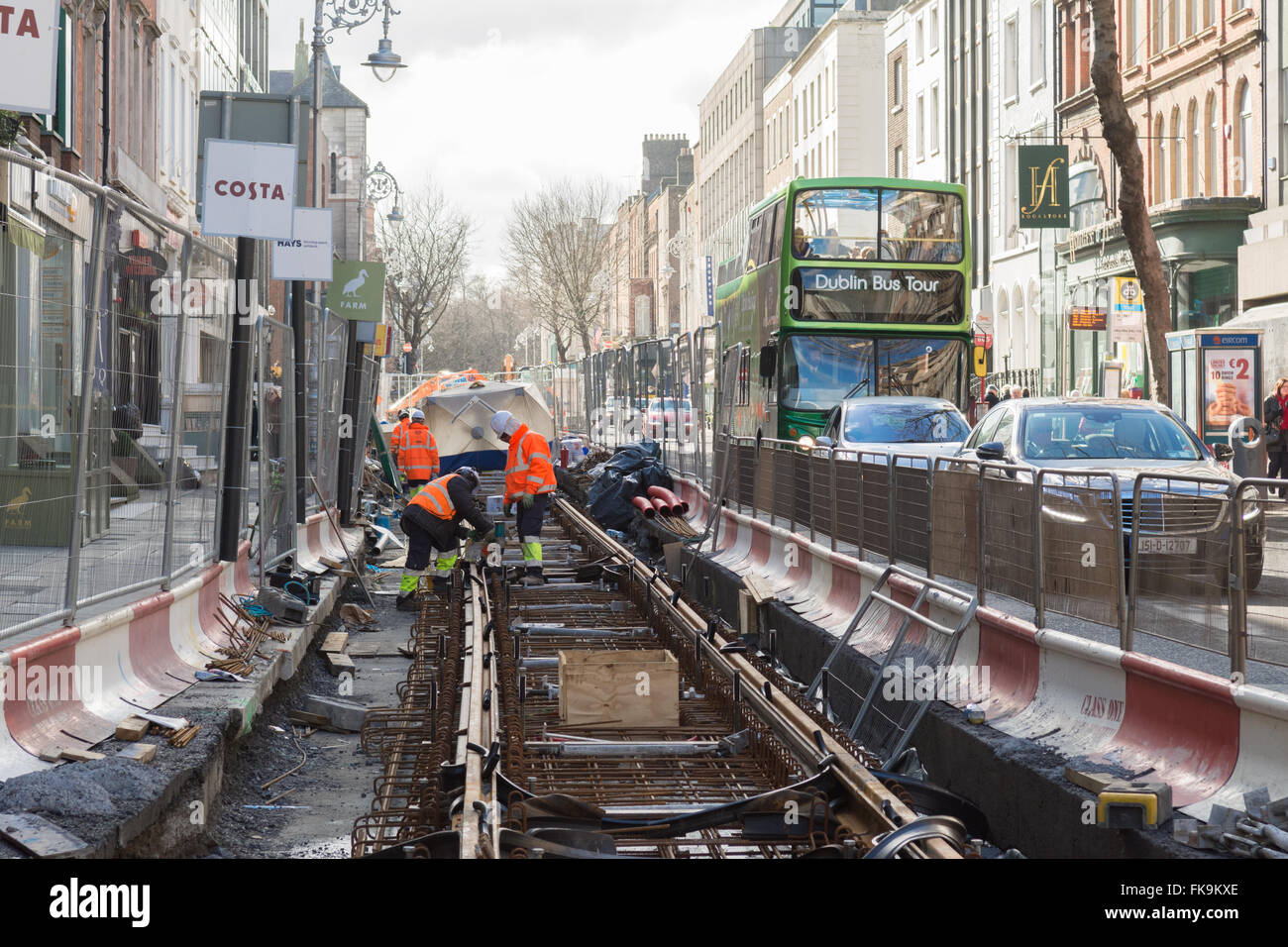 Construction workers building the extension to the Luas Green Line tram ...
