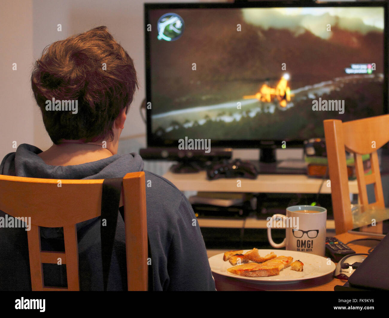 Teenager playing an XBox game Stock Photo - Alamy