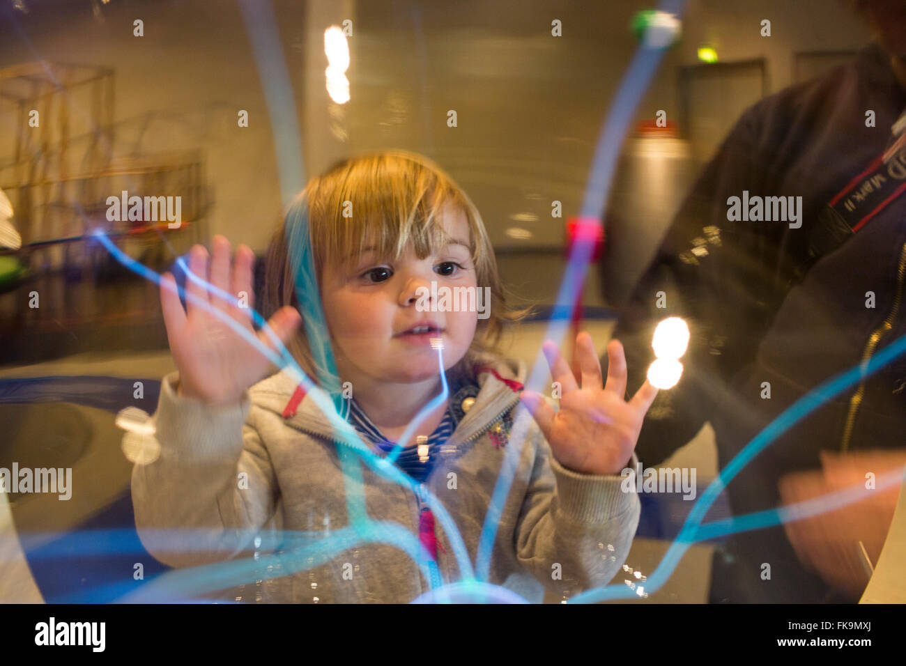 Little girl looking at a static electricity ball Stock Photo - Alamy