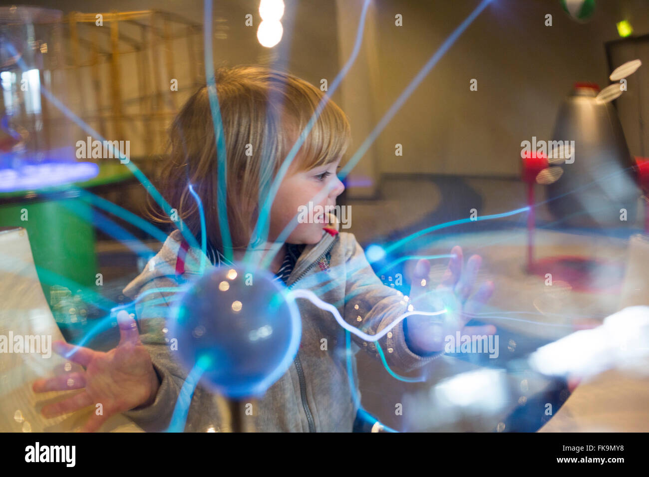 Little girl looking at a static electricity ball Stock Photo - Alamy
