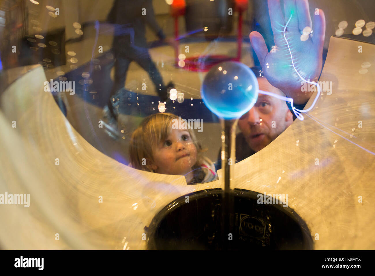 Little girl looking at a static electricity ball Stock Photo - Alamy
