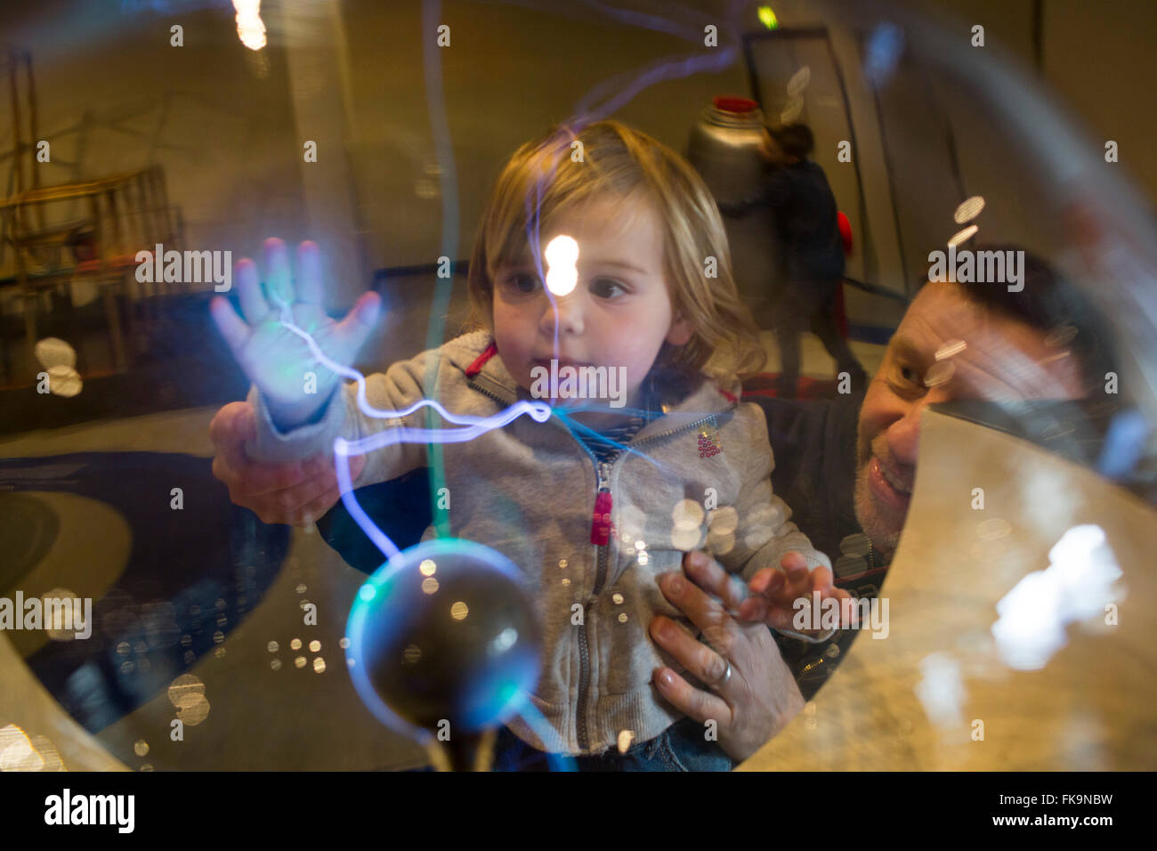 Little girl looking at a static electricity ball Stock Photo - Alamy