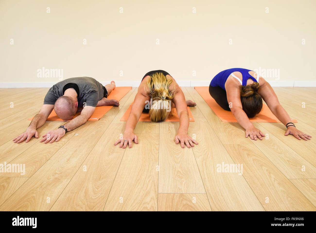 Yoga positions in studio Stock Photo - Alamy