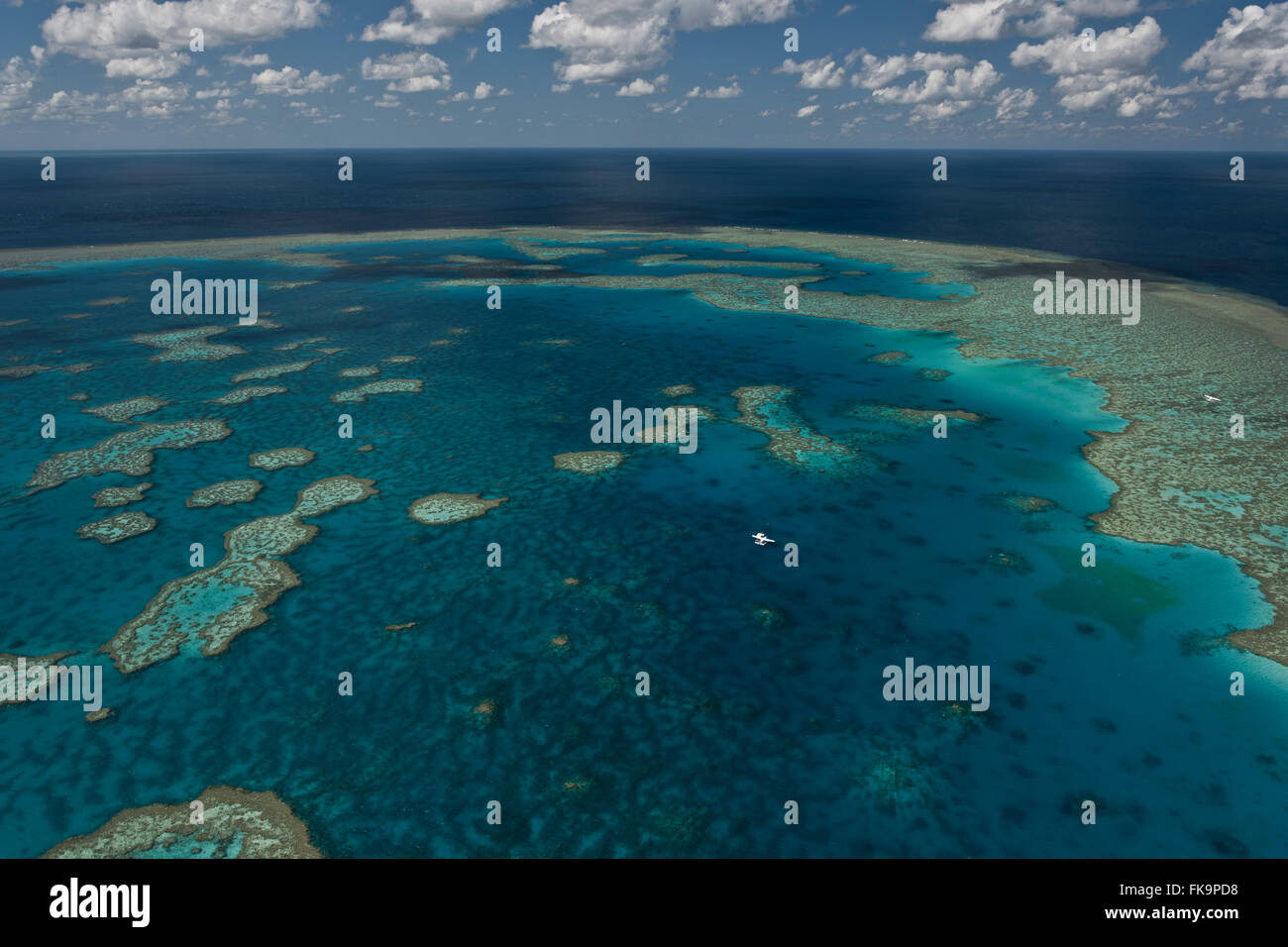 Aerial view of Hardy Reef with float plane, home to the heart reef, in ...