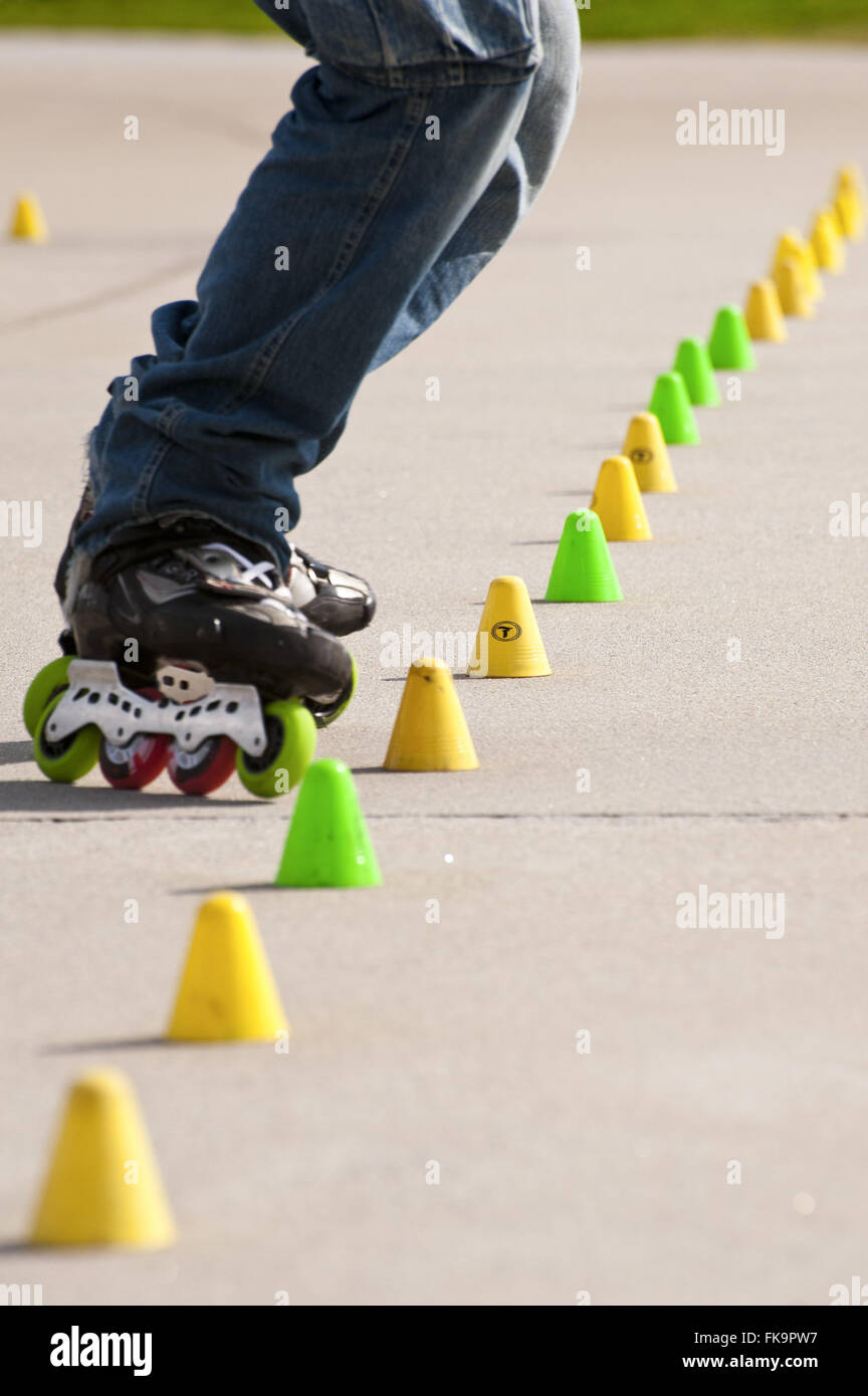 Skater dodging obstacles on the ground in park Stock Photo - Alamy