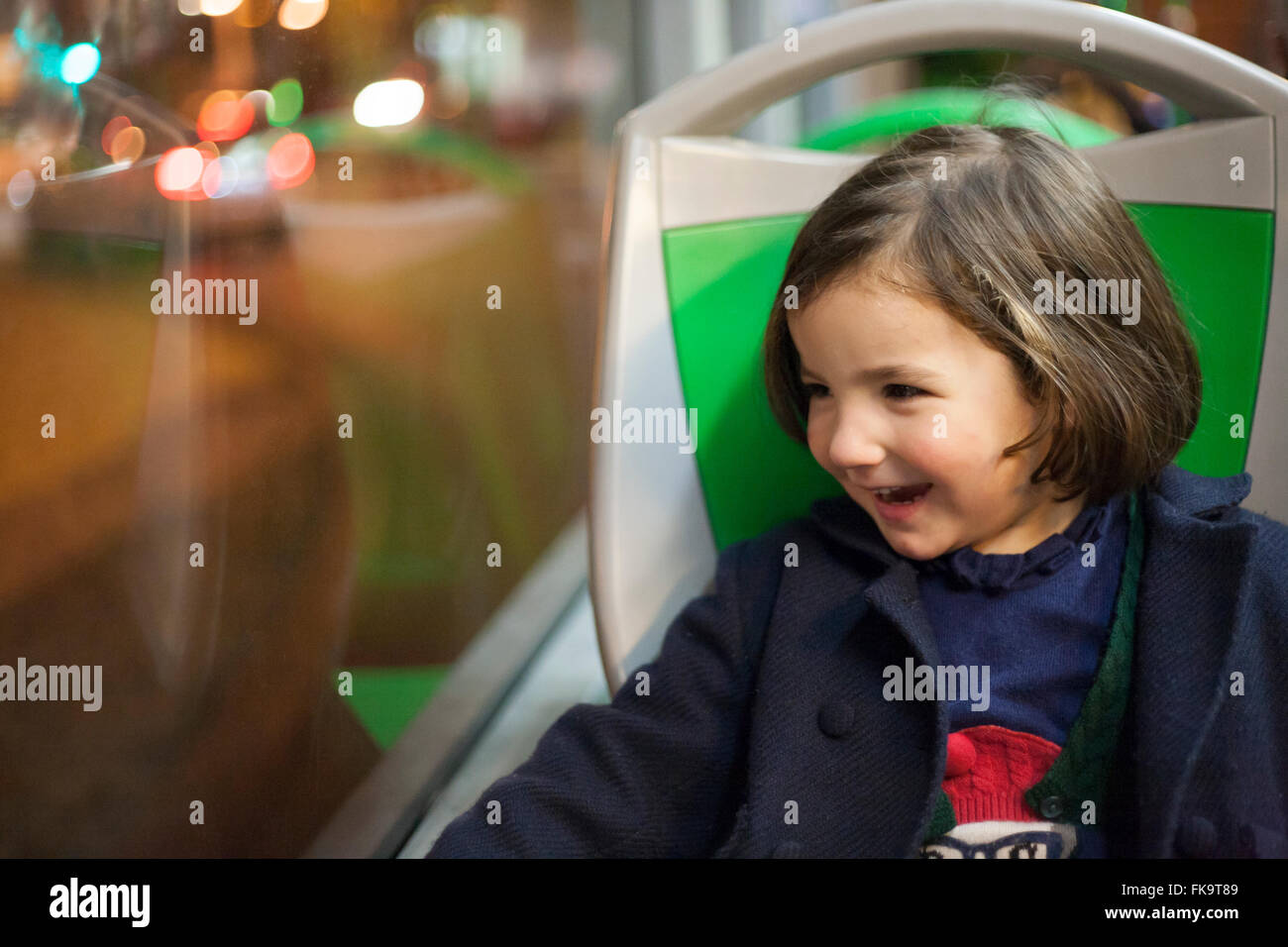 Little girl having fun at urban bus at night Stock Photo - Alamy