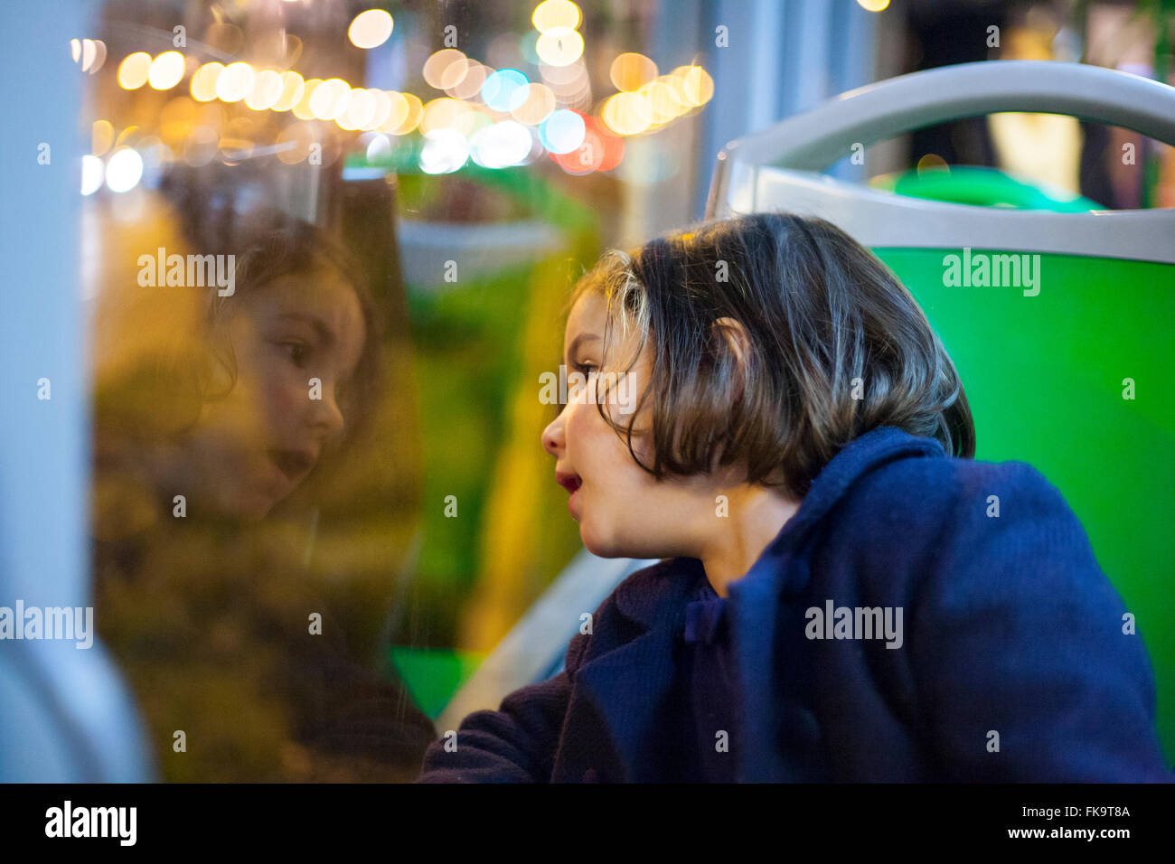 Little girl having fun at urban bus at night Stock Photo - Alamy