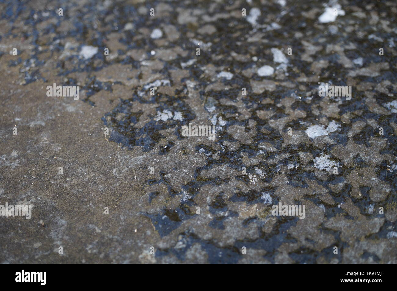 Black ice on sidewalk pavement after a snowfall in winter Stock Photo ...