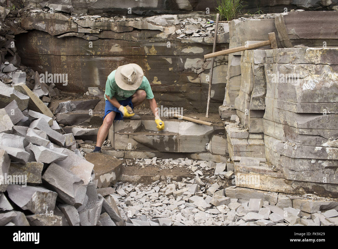Worker extracting basaltic rocks Stock Photo - Alamy