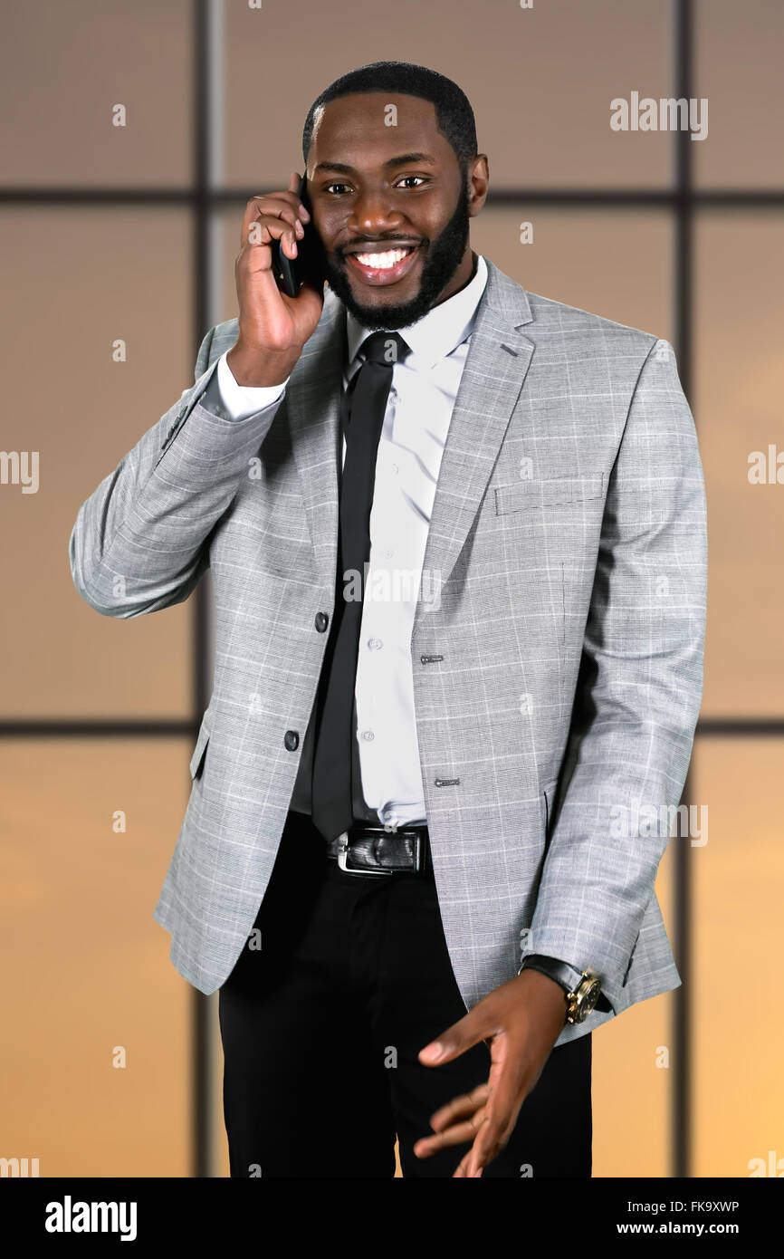 Kind afro manager in office Stock Photo - Alamy