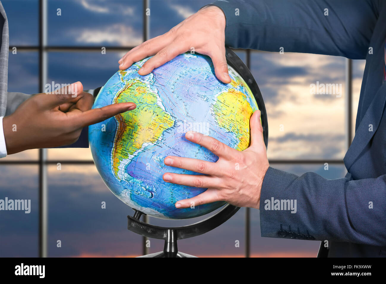 Businessmen with globe in office Stock Photo - Alamy