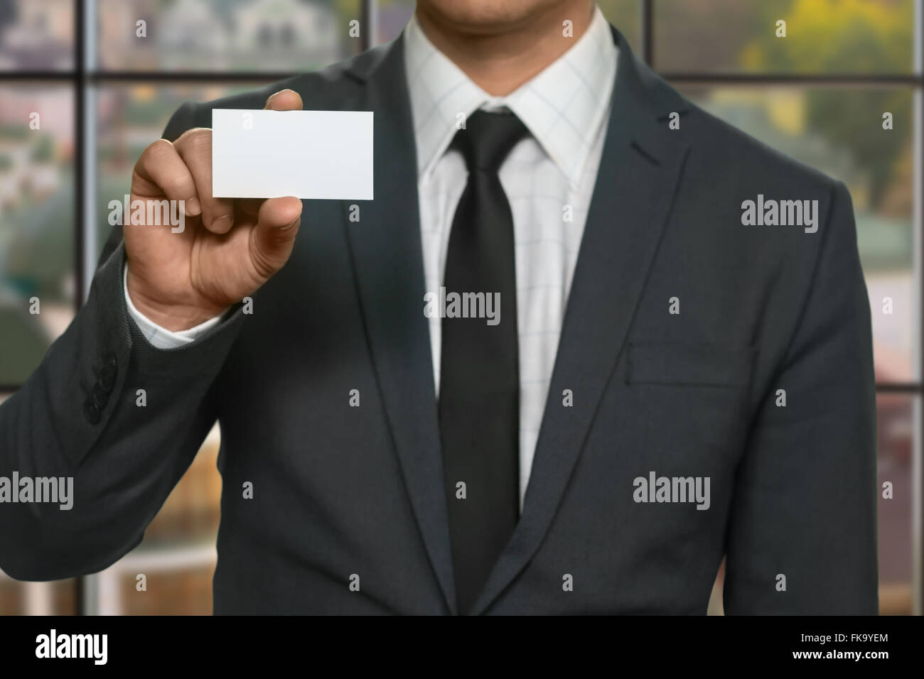 Office manager shows visit card Stock Photo - Alamy