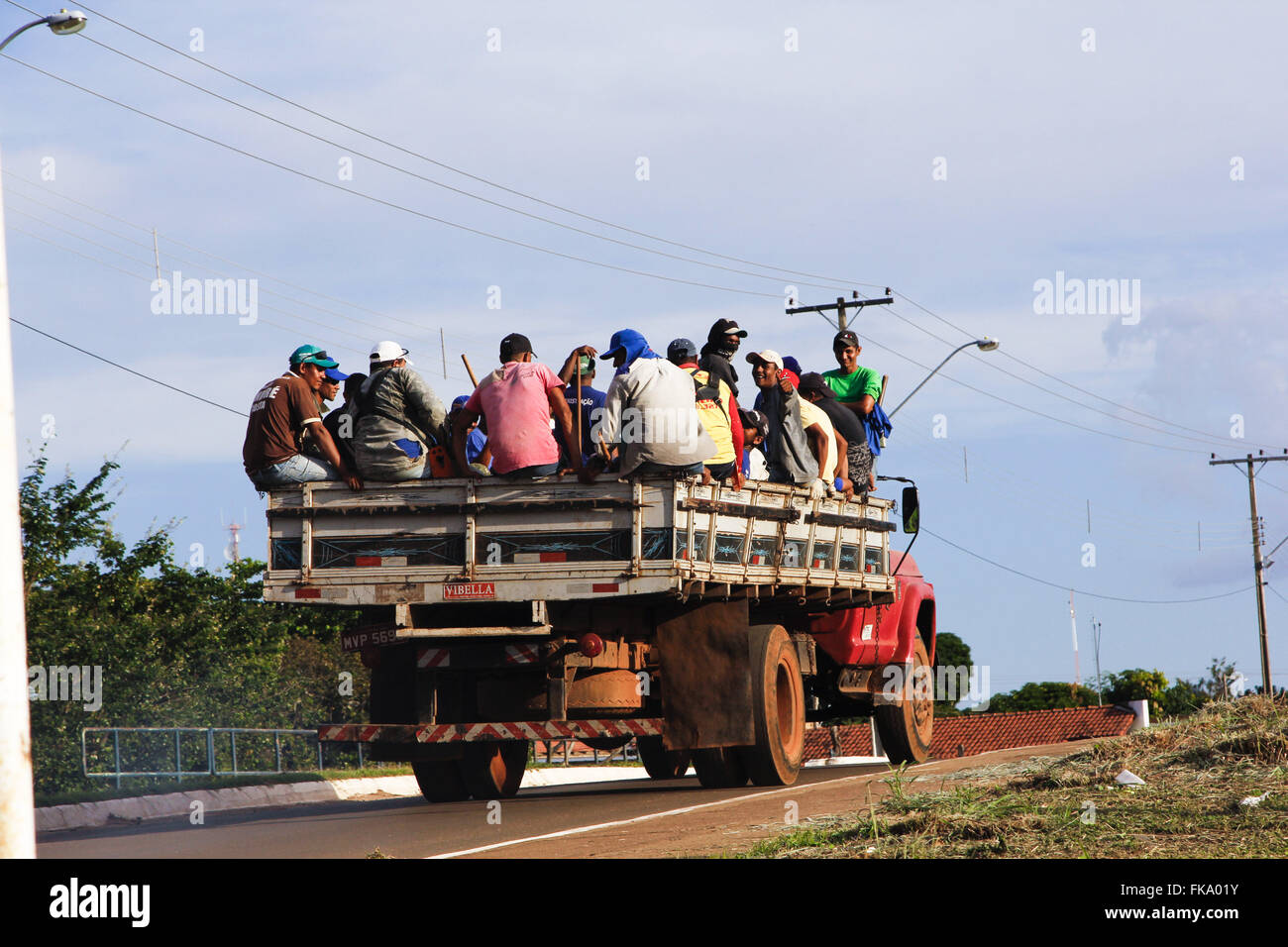 Transport workers in body of truck Stock Photo - Alamy