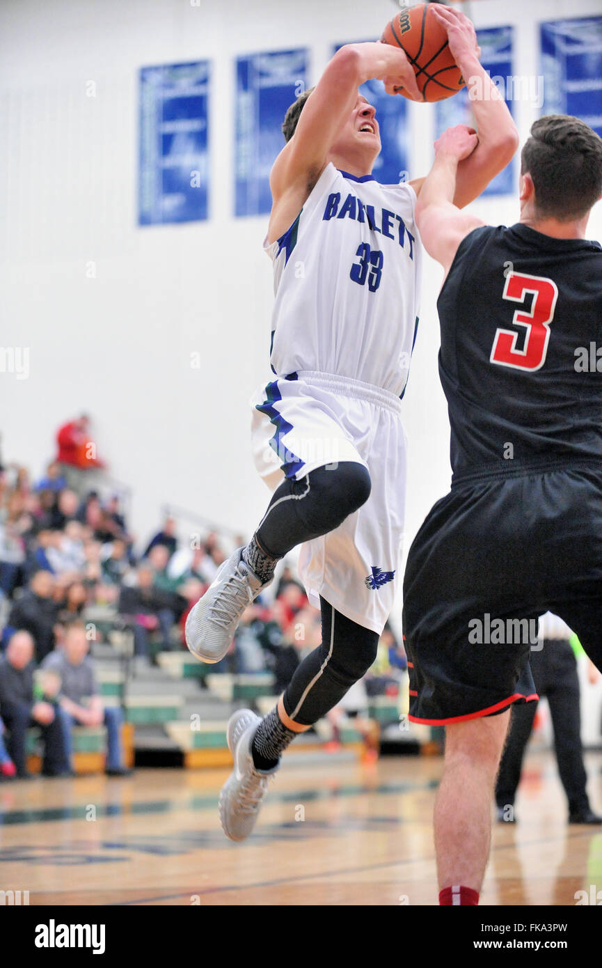 Player finishing off a drive and shooting over a defender during a high ...