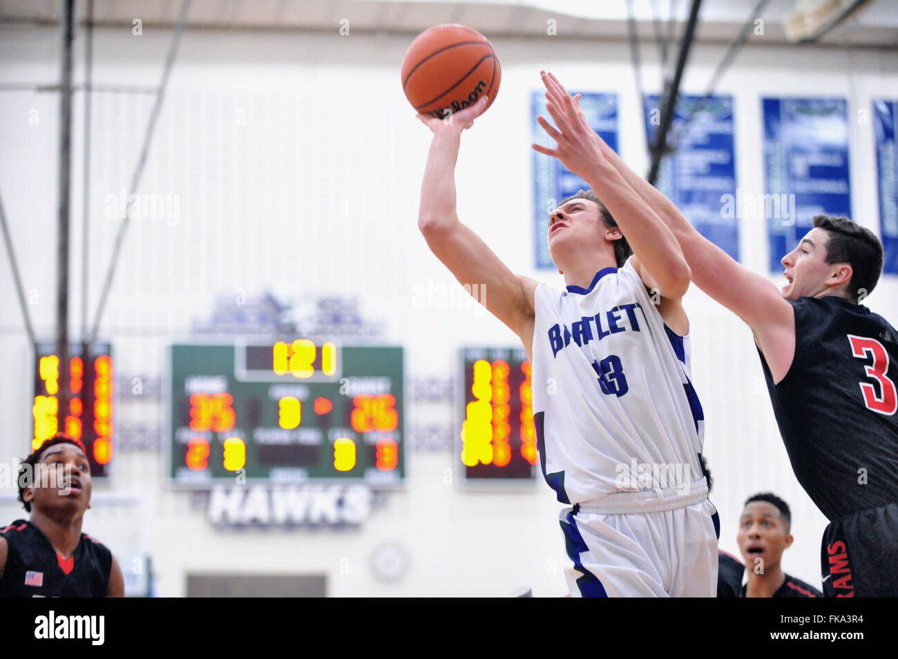 Player finishing off a drive and shooting in front of a defender during ...