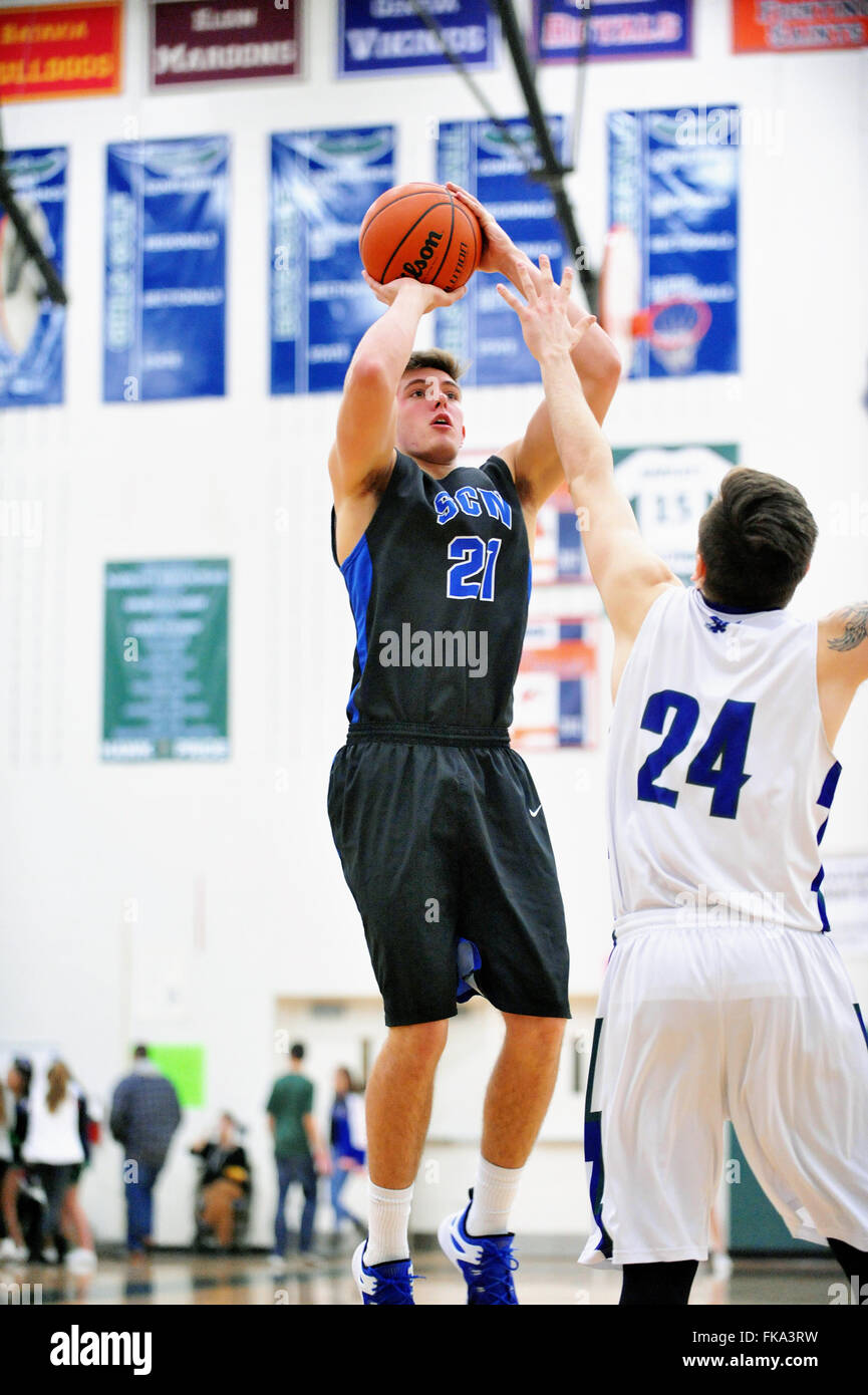 Player pulling up to take a jump shot over a defender during a high ...