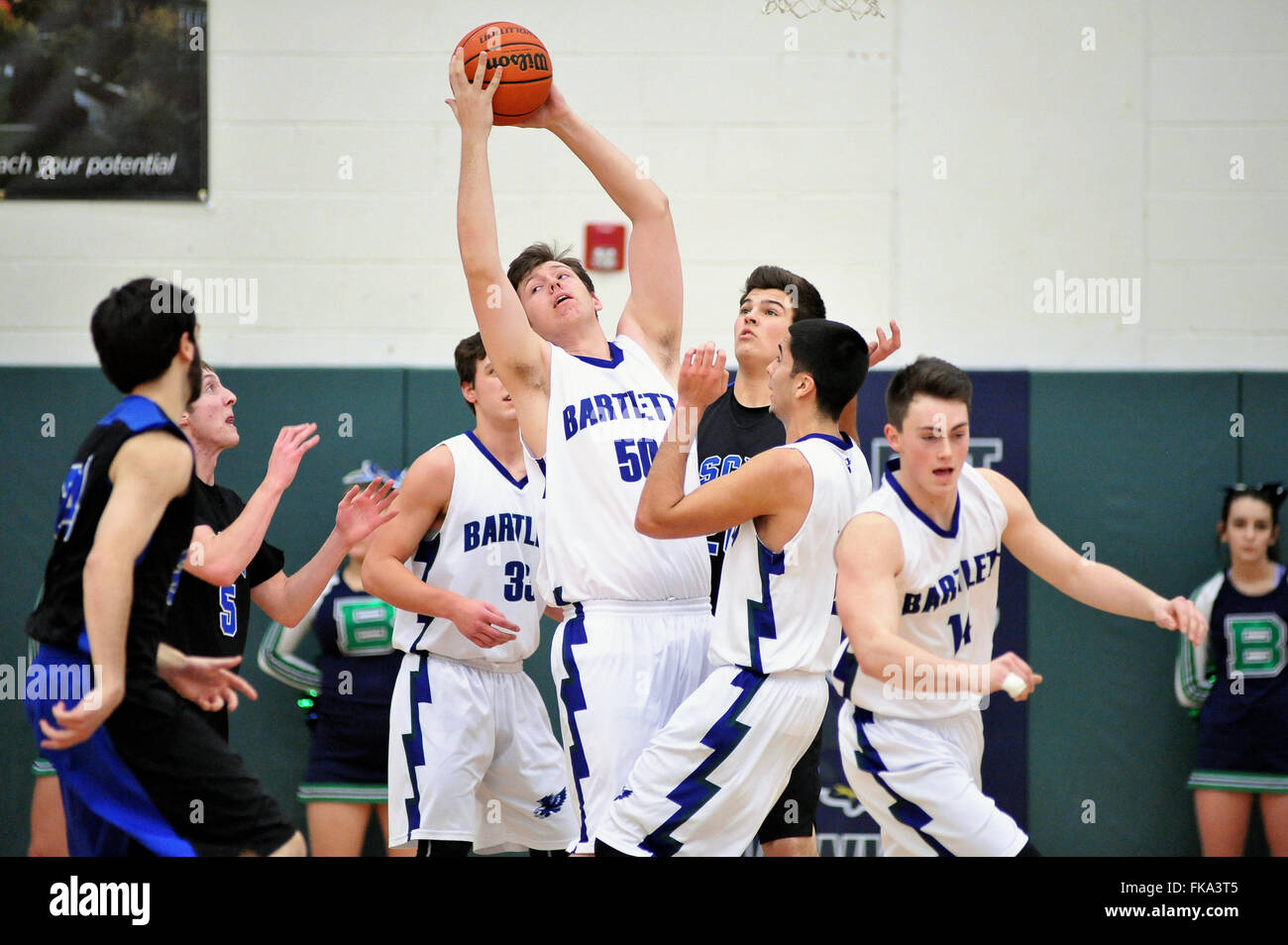 Players battling for a rebound in the midst of a cluster during a high ...