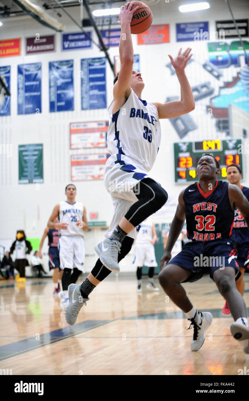 Player delivering an uncontested layup while traveling above the lane ...