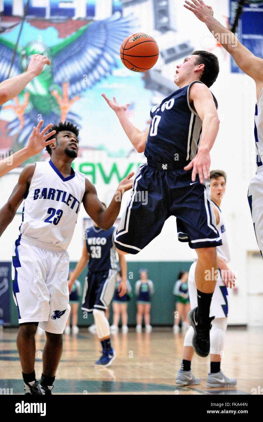 During a drive on the basket, a player reaches back for the basketball ...