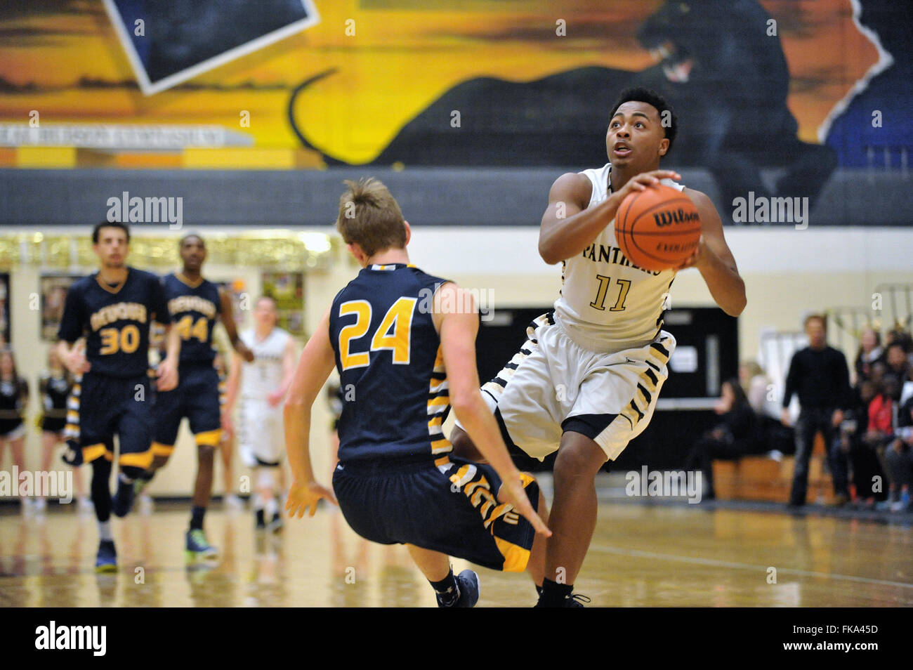 Player staying focused on the hoop while controlling the basketball ...