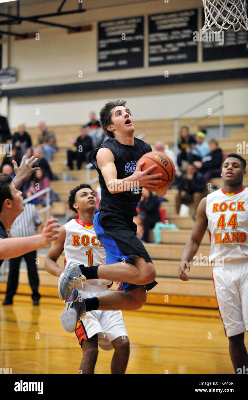 An airborne player on a flight to the hoop after passing a pair of ...