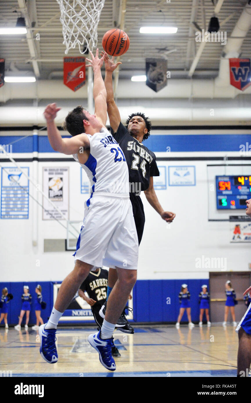 Defender extending in an effort to block a shot from just under the ...