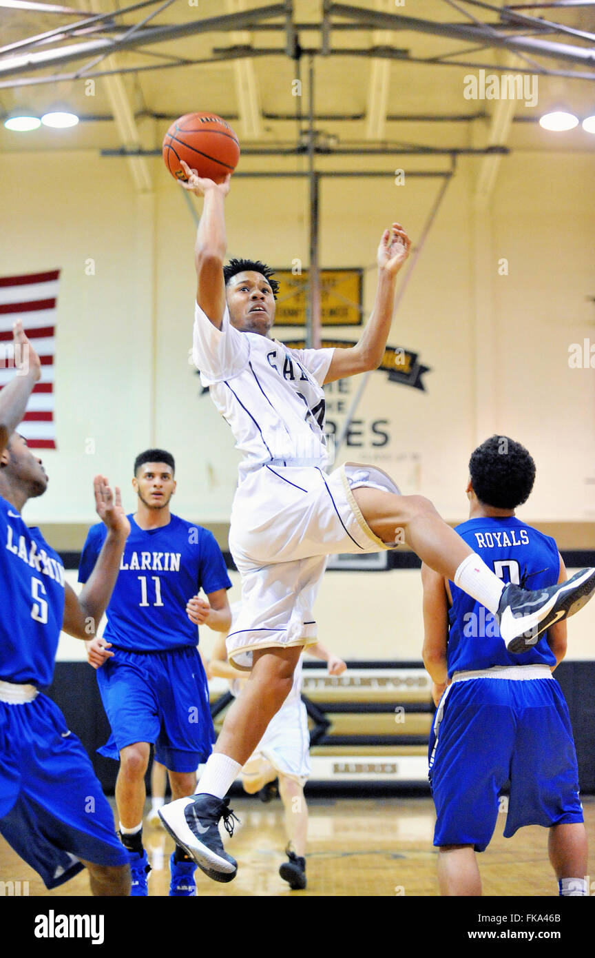 A player going to the air in a scoring effort over defenders during a ...