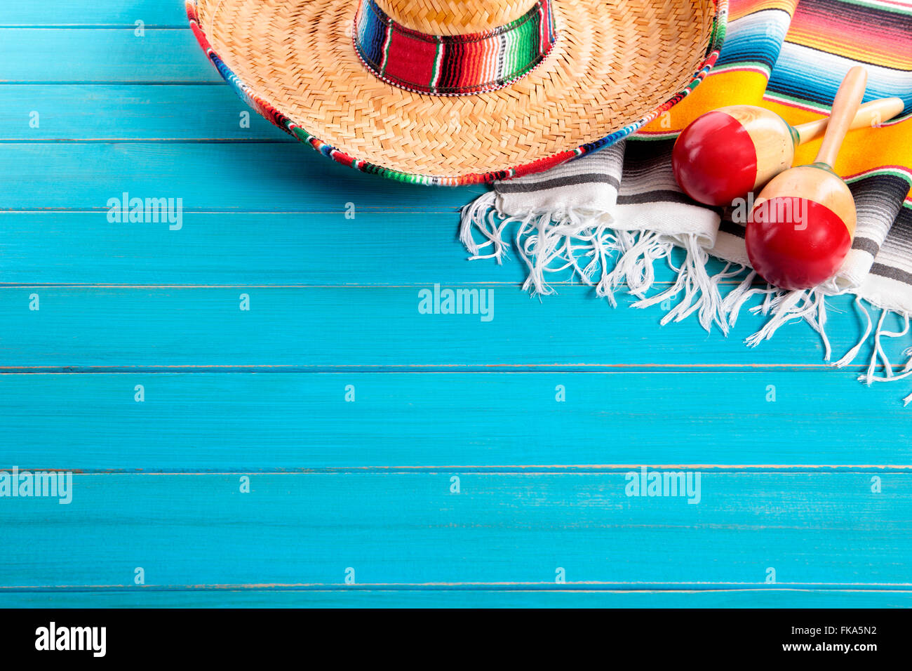 Mexican sombrero and maracas with traditional serape blanket laid on an ...