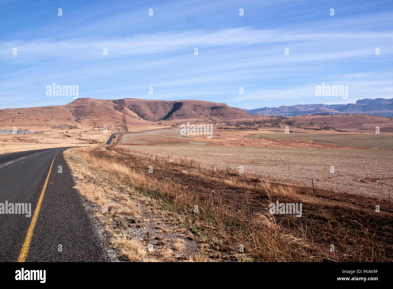 asphalt country road stretching through a dry winter landscape in ...