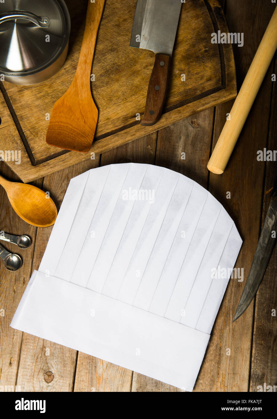 Chef hat and wooden spoons on wooden table Stock Photo - Alamy