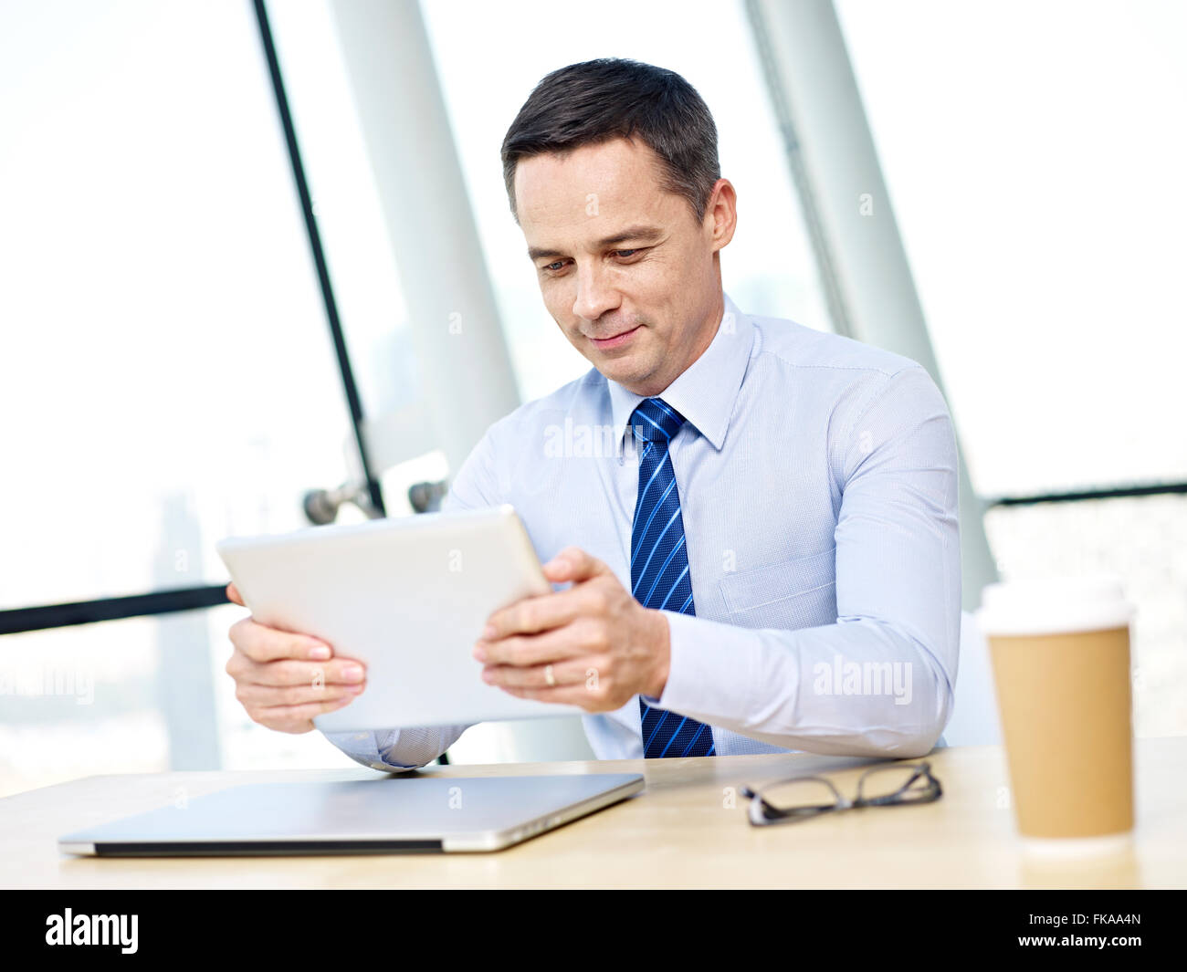 business man using ipad in office Stock Photo - Alamy