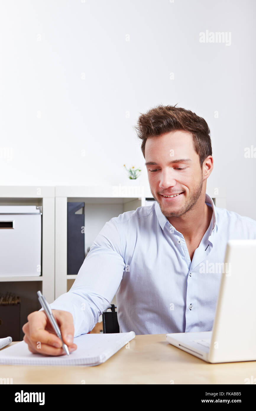 College student learning with computer and taking notes Stock Photo - Alamy