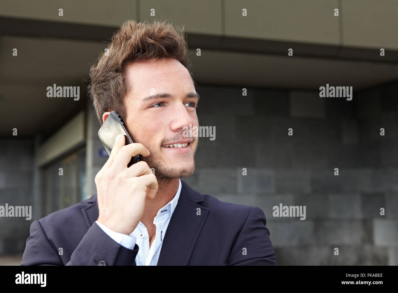 Young business man making cell phone call in urban city Stock Photo - Alamy