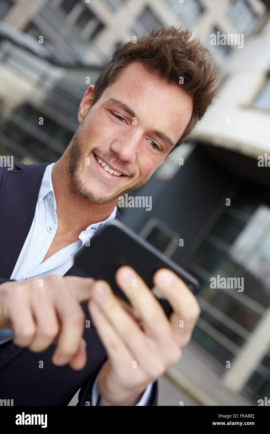 Young business man navigating in urban city with smartphone Stock Photo ...