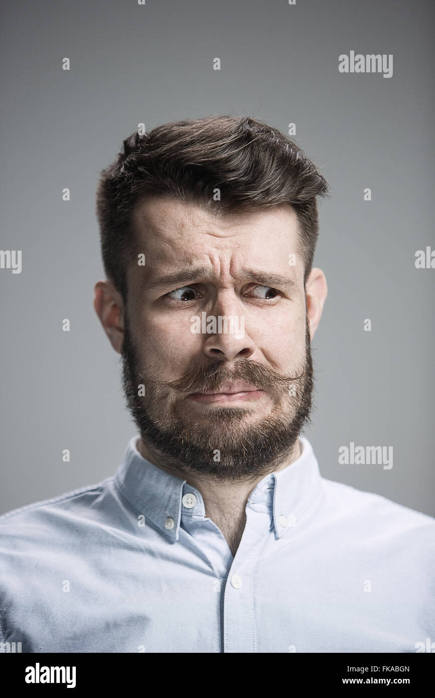 The portrait of disgusted man on gray Stock Photo - Alamy