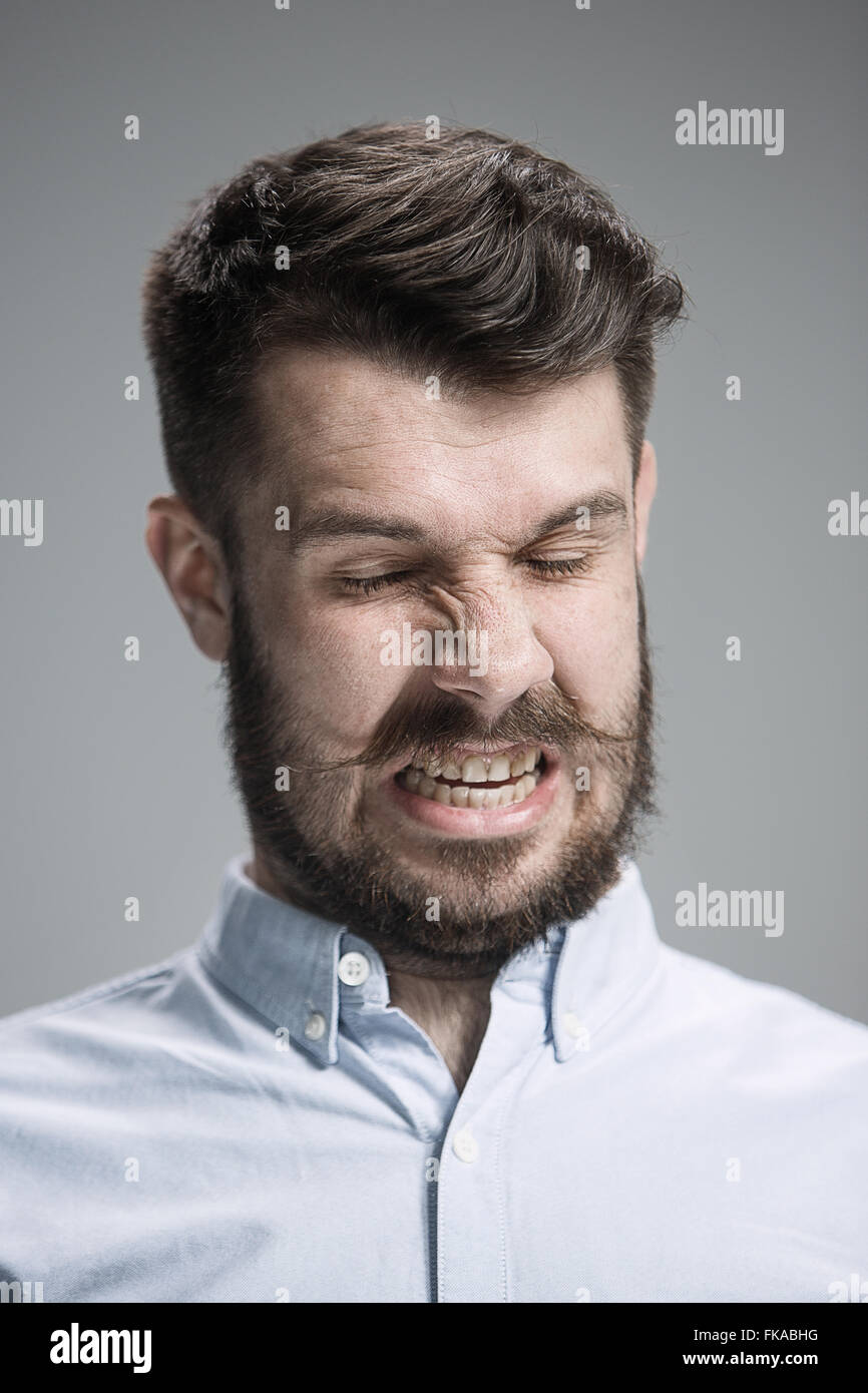 The portrait of disgusted man on gray Stock Photo - Alamy