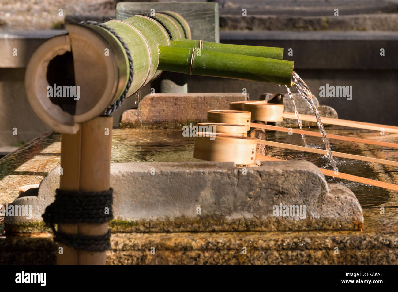 Water basin and purification ladles at Shinto temple in Kyoto, Japan ...
