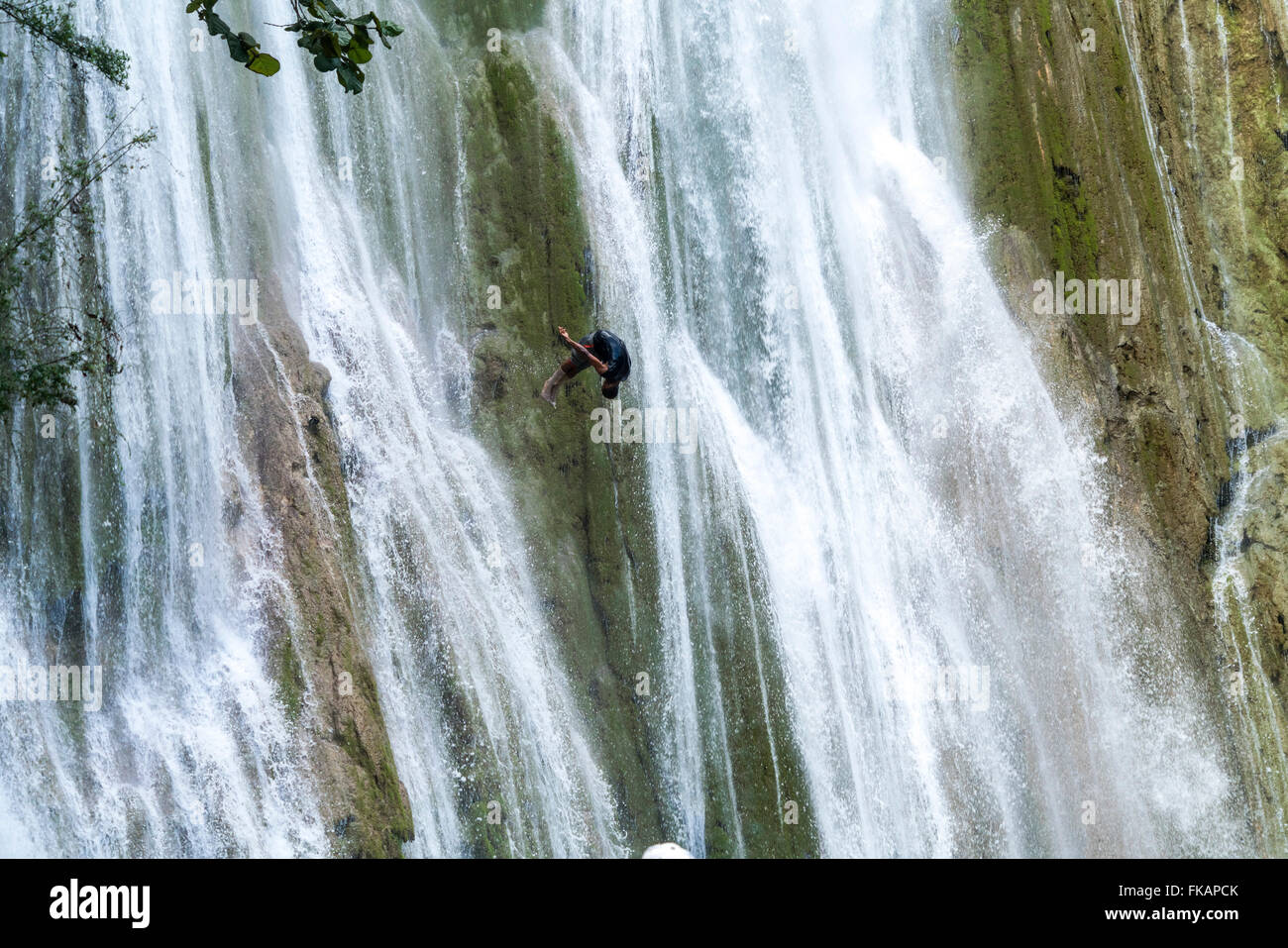 young man jumping into the waterfall Salto El Limon in Limon near Las ...
